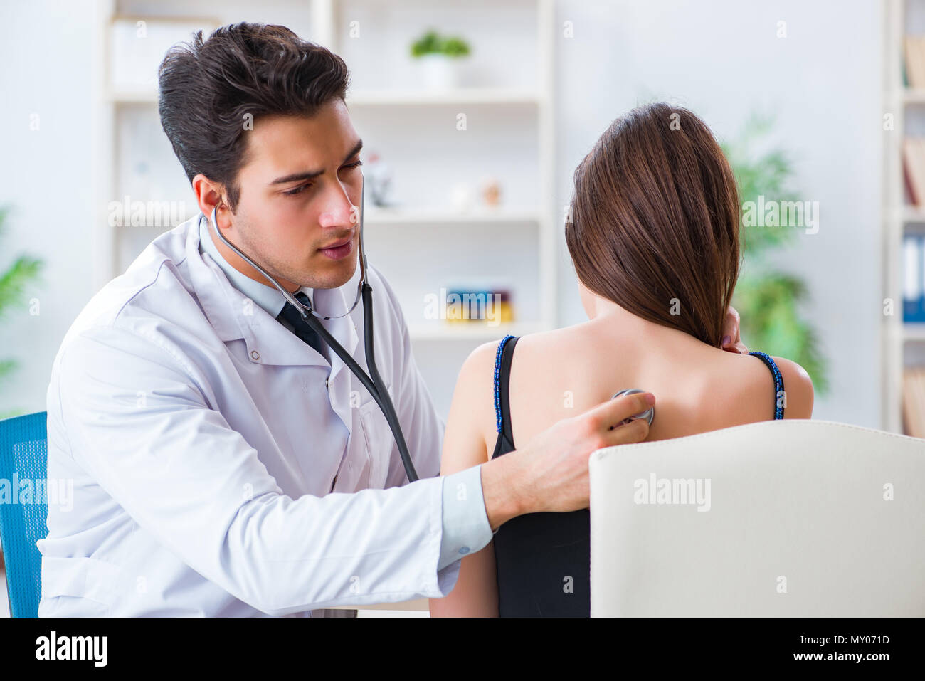 Doctor checking patient with stethoscope Stock Photo - Alamy