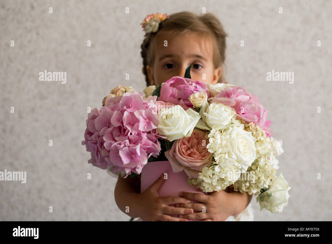 little girl with a big bouquet of fresh flowers, the emotions of a ...