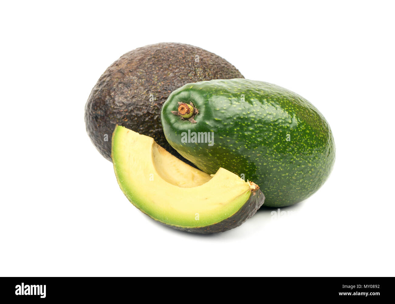 Two avocado with a slice on white background Stock Photo - Alamy