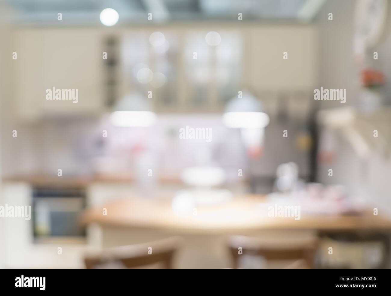 Blurred background modern kitchen and dinning room in house with bokeh ...