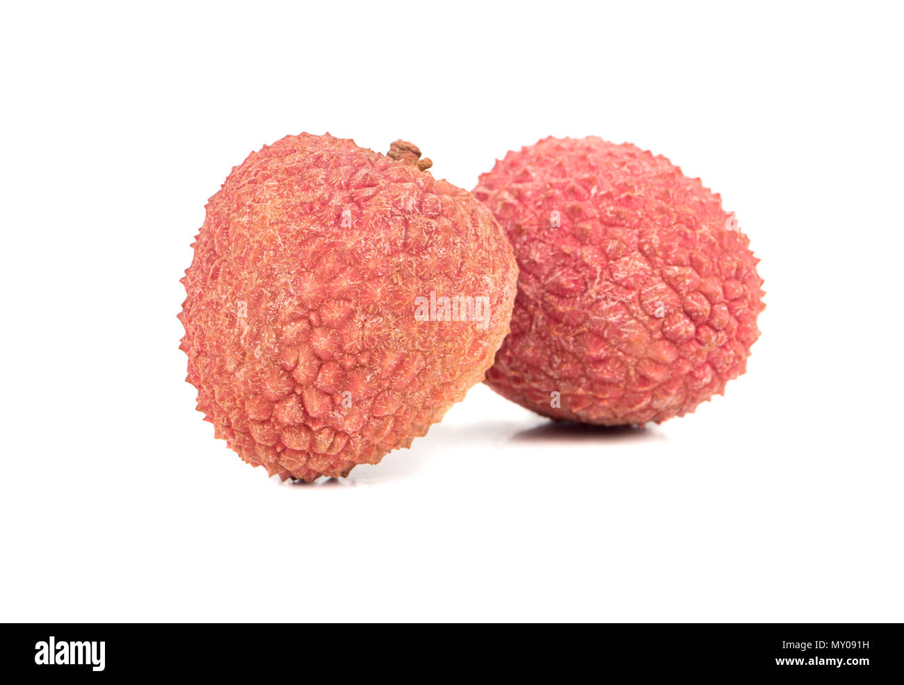 Two lychee fruit in shell isolated on white background Stock Photo - Alamy