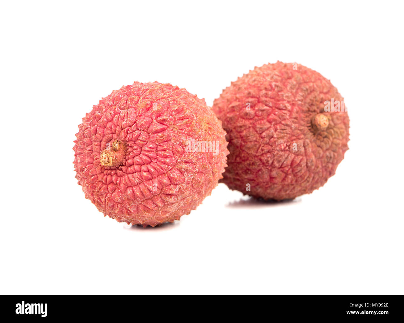 Two lychee fruit isolated on white background Stock Photo - Alamy