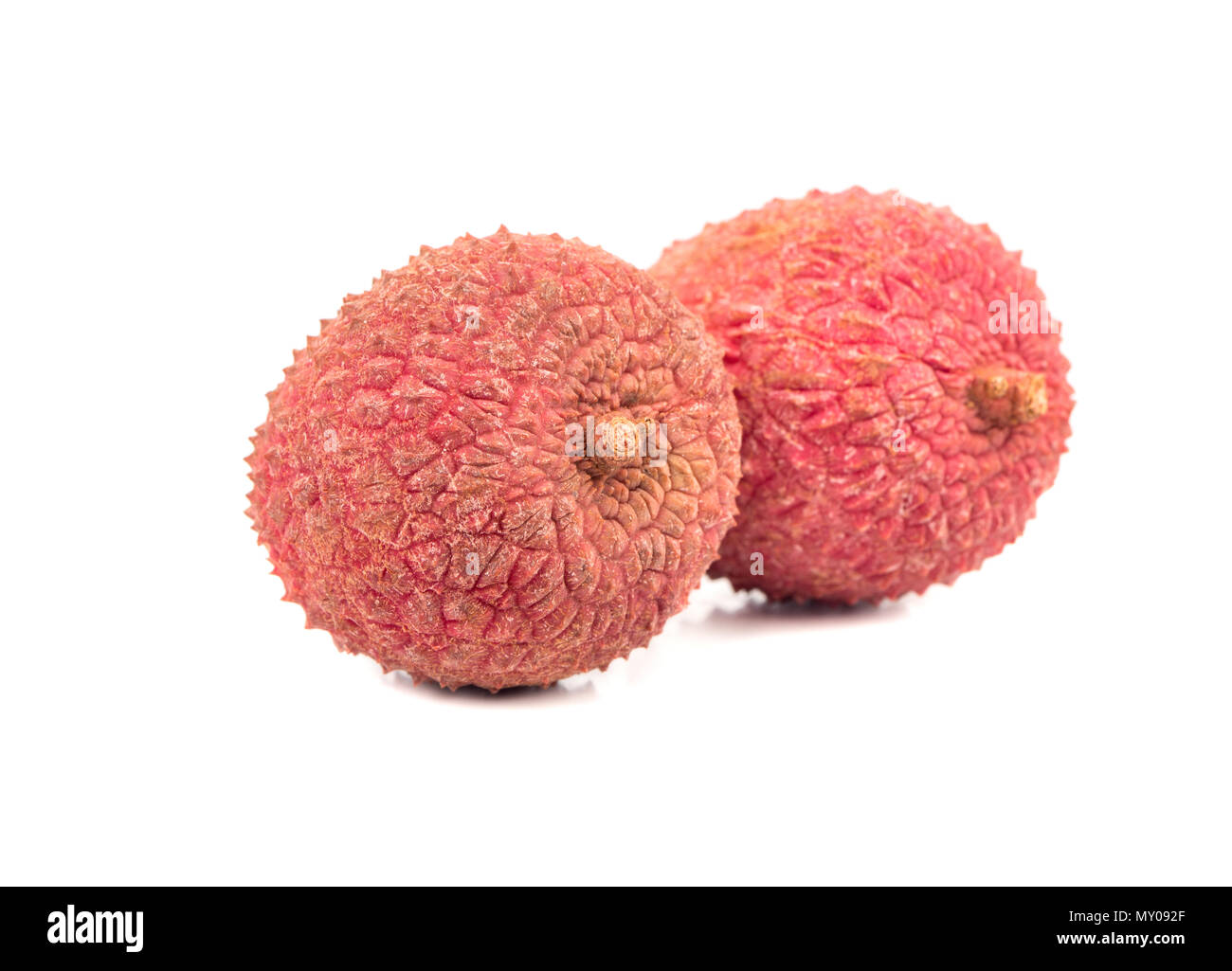 Two lychee fruit isolated on white background Stock Photo - Alamy