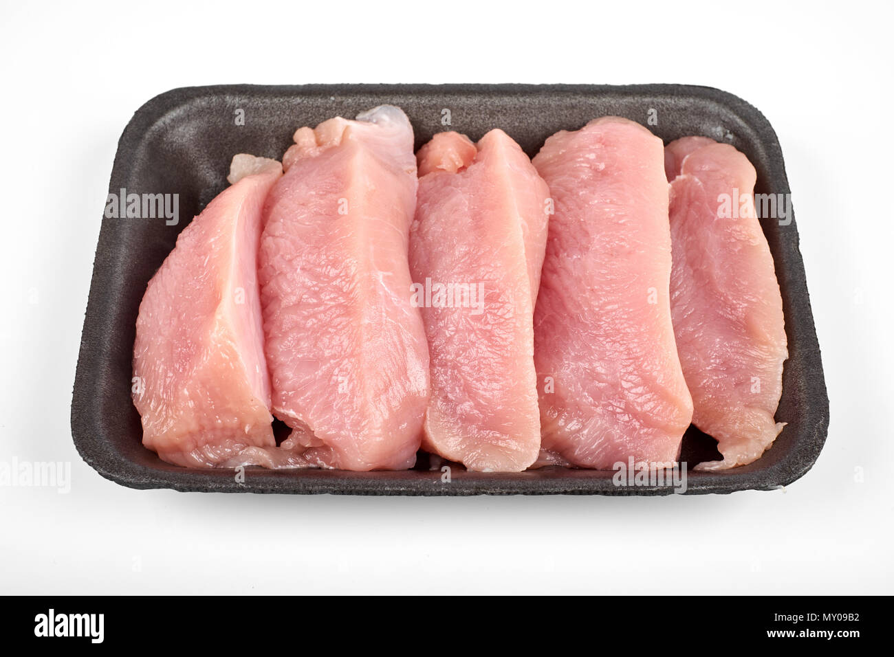 Raw dietary turkey meat pieces in tray, isolated on white background ...