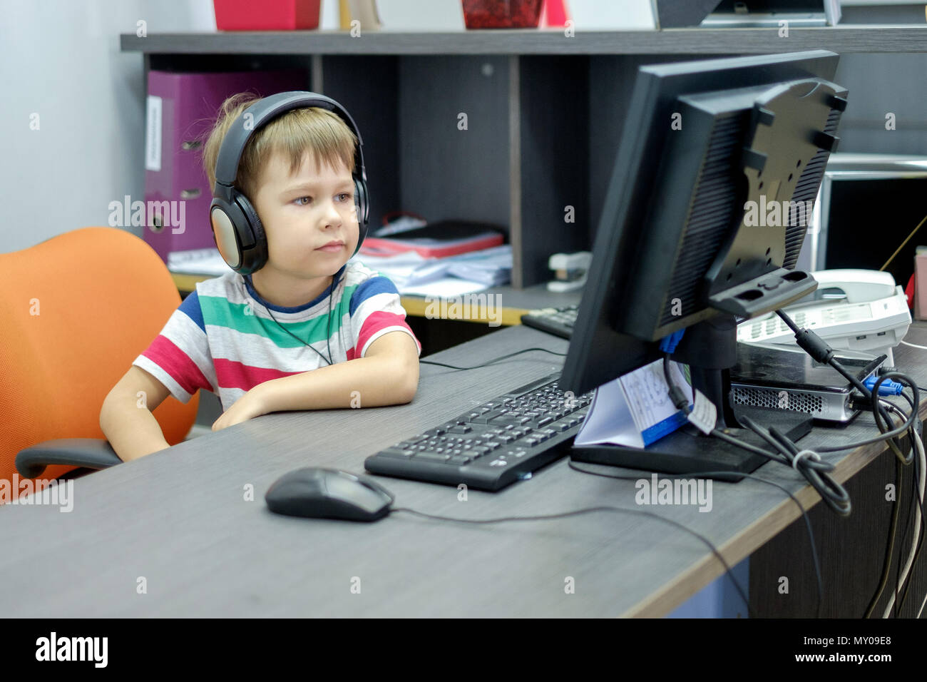Boy using computer with headphones hi-res stock photography and images ...