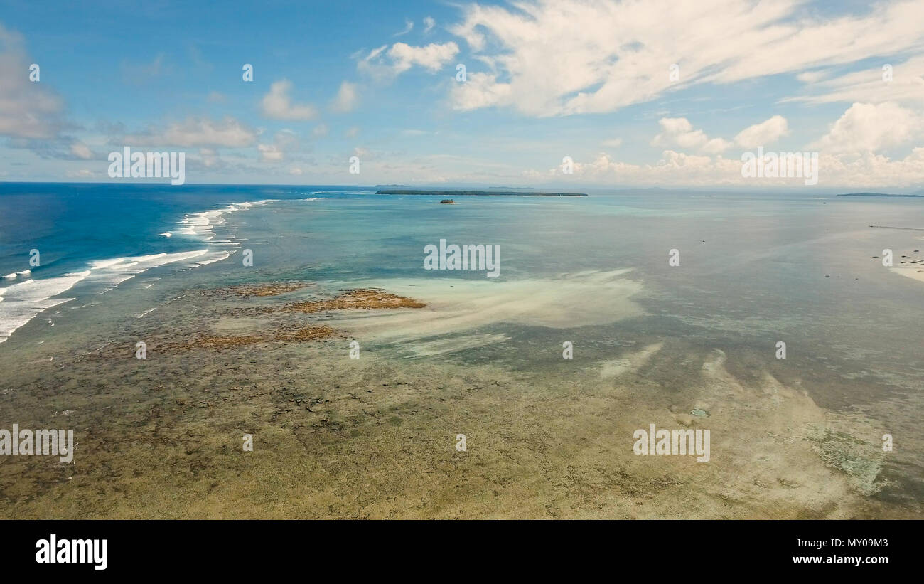 Flying over the blue sea in the azure lagoon. Aerial view: water ...