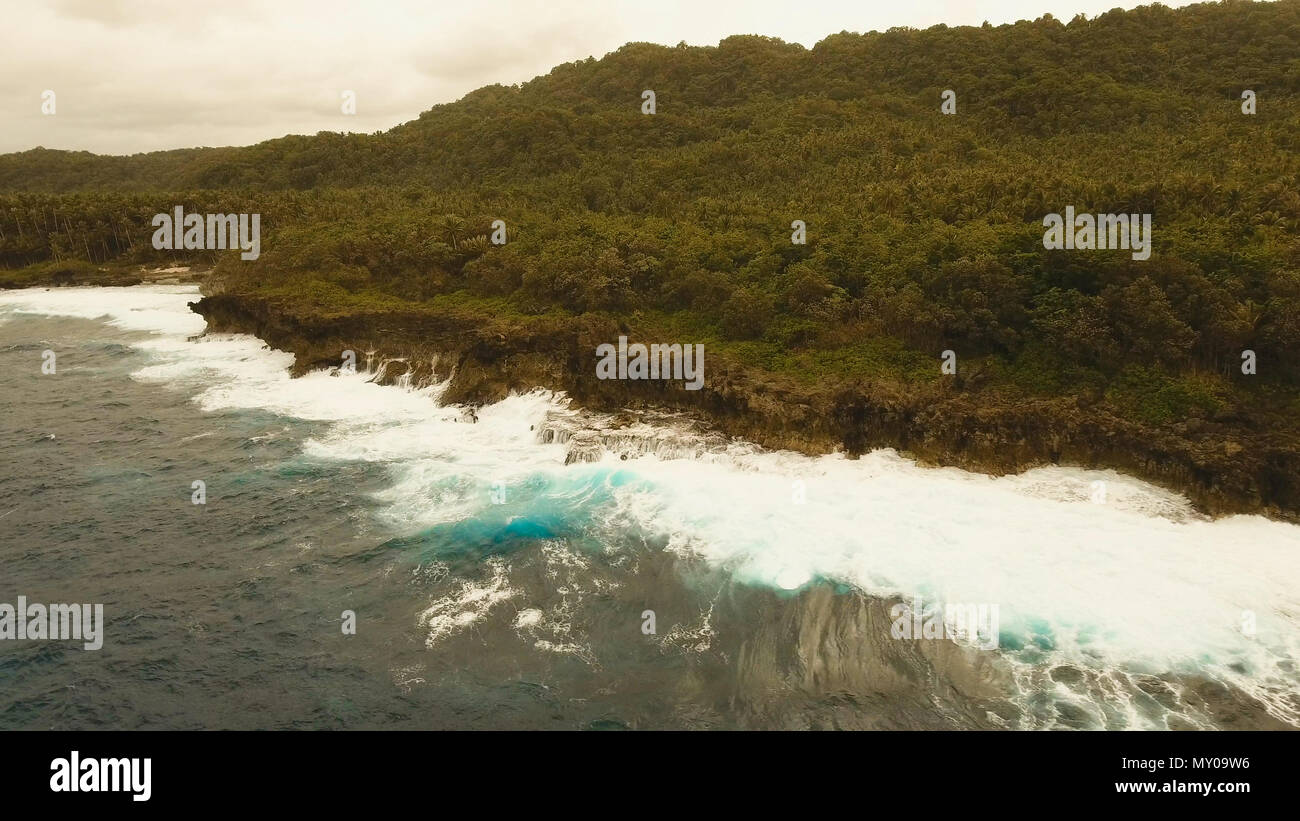 Rocky coast line in time stormy weather on island Siargao. Aerial view ...