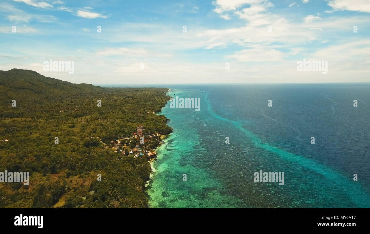 Aerial view: sea and the tropical island with beach,resort, hotels ...
