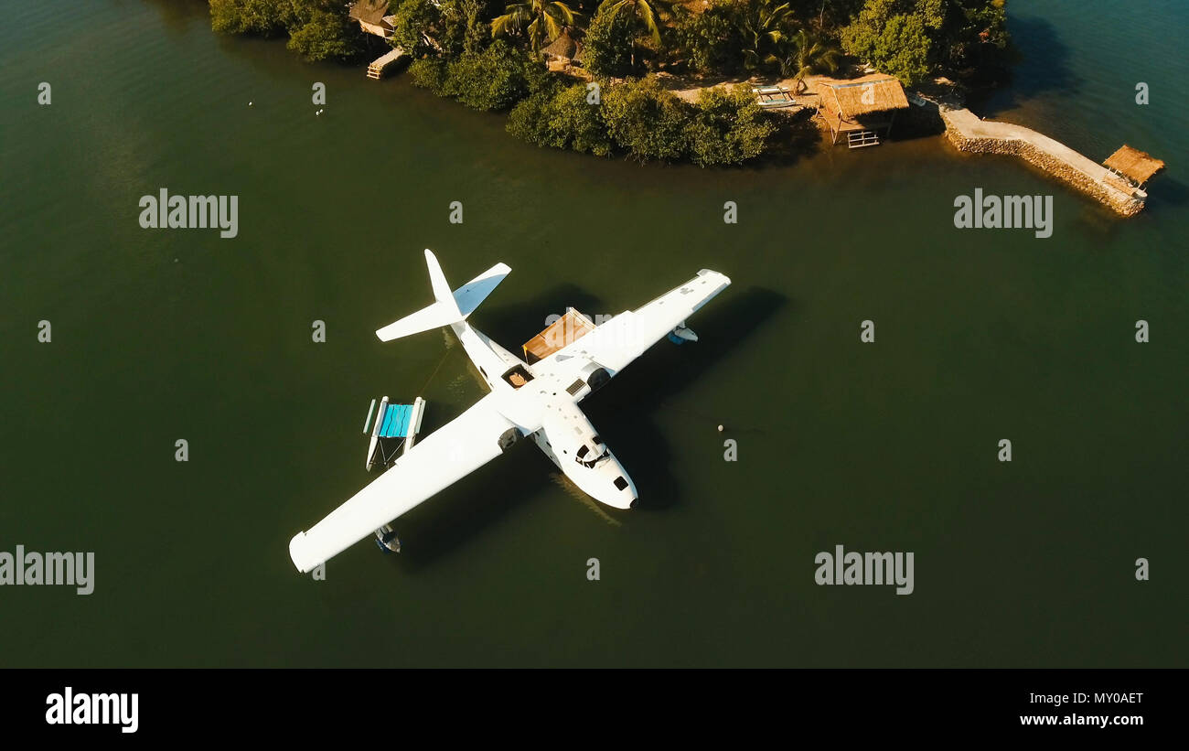 Aerial view: White Seaplane parked in the sea bay of the tropical ...
