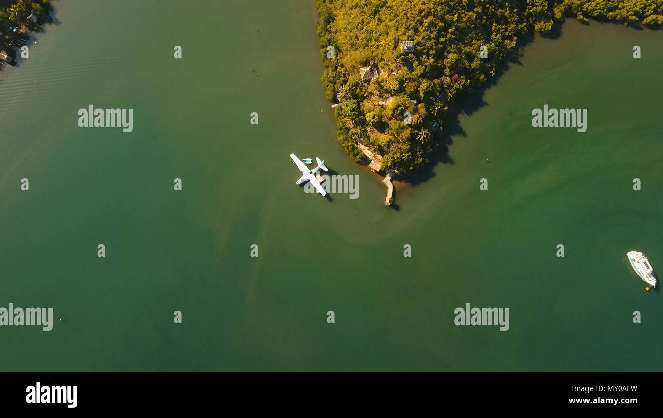 Aerial view: White Seaplane parked in the sea bay of the tropical ...