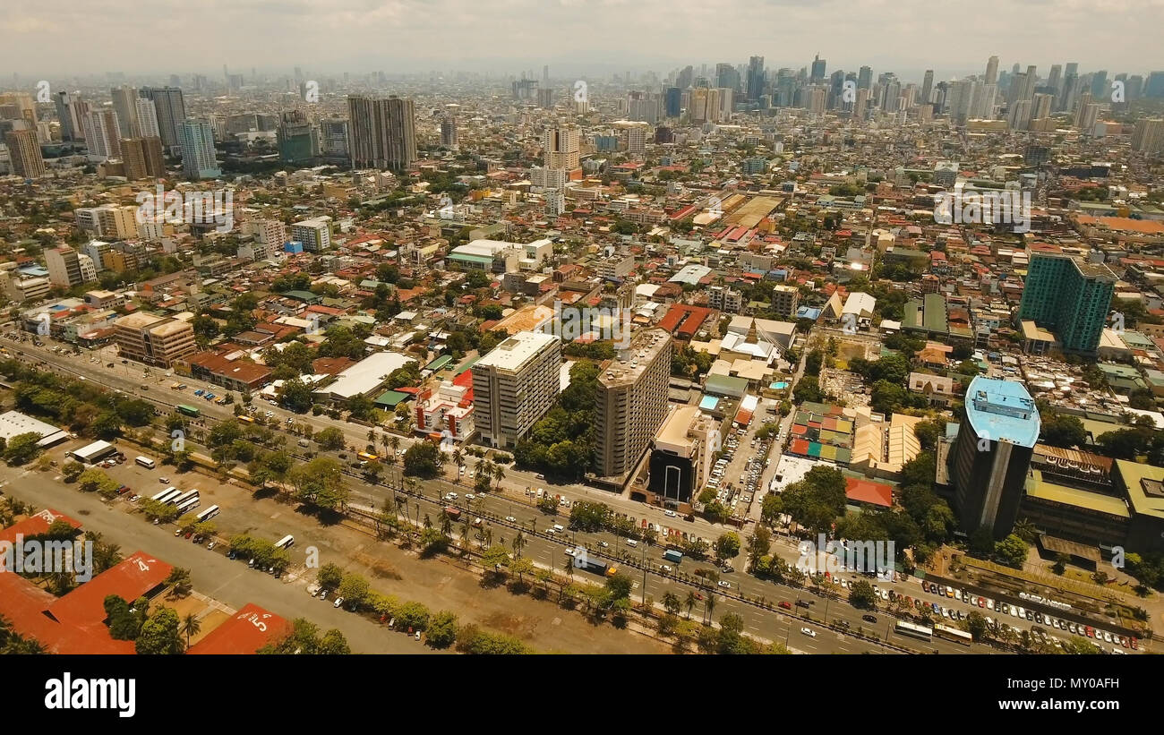 Aerial view of Manila city. Fly over city with skyscrapers and ...