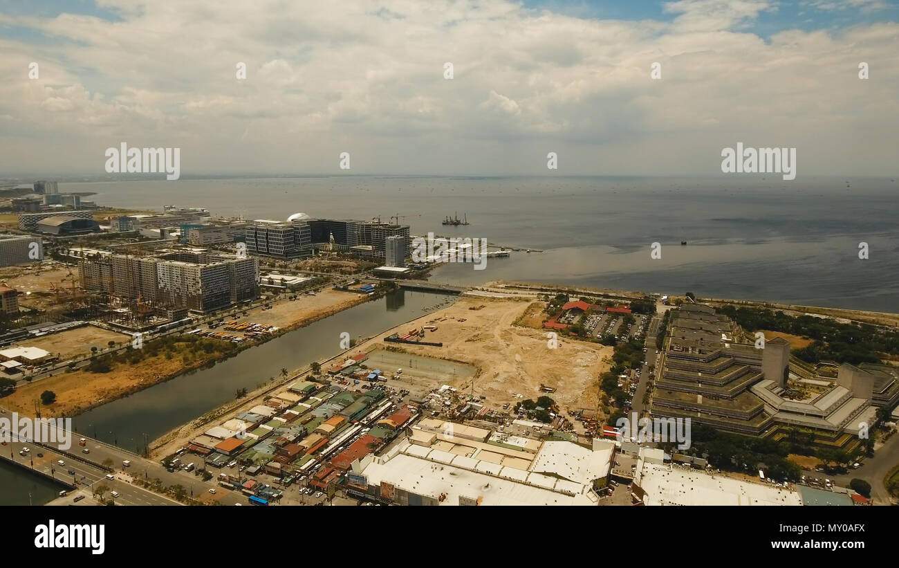 Aerial view of Manila city. Fly over city with skyscrapers and ...