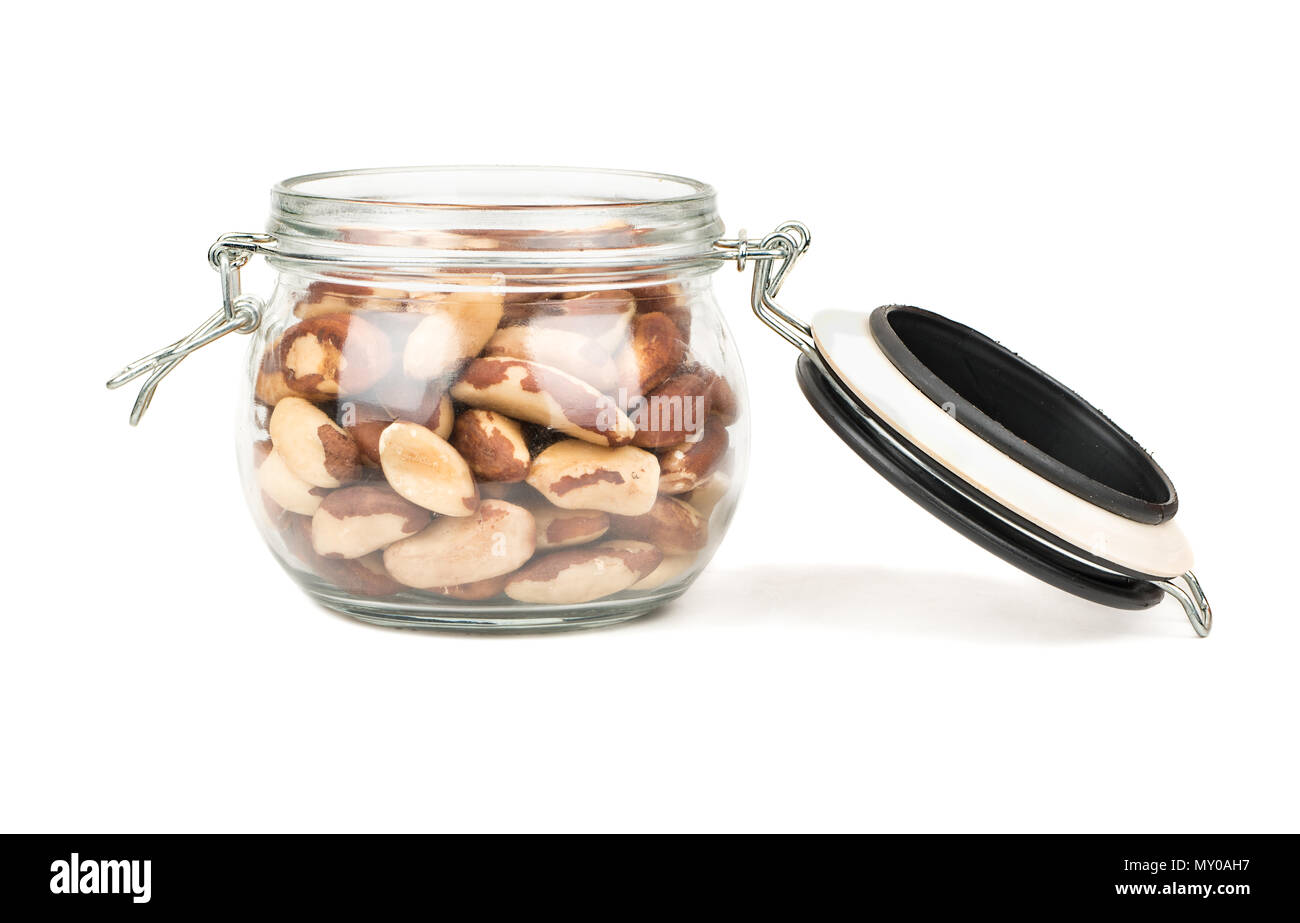 Open jar with Brazil nuts isolated on white background Stock Photo - Alamy