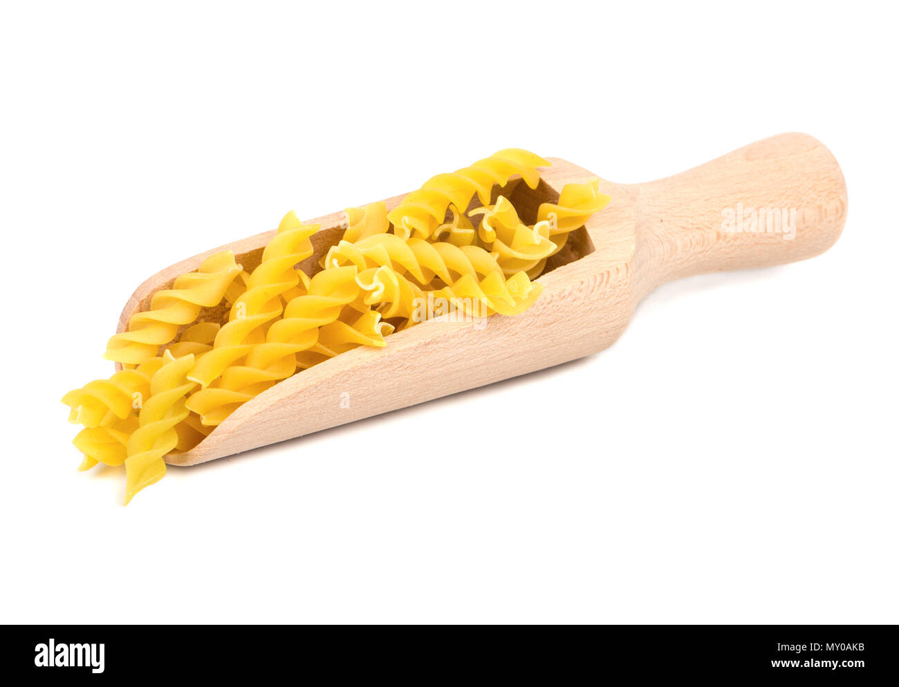 Uncooked pasta fusilli in scoop on white background Stock Photo - Alamy