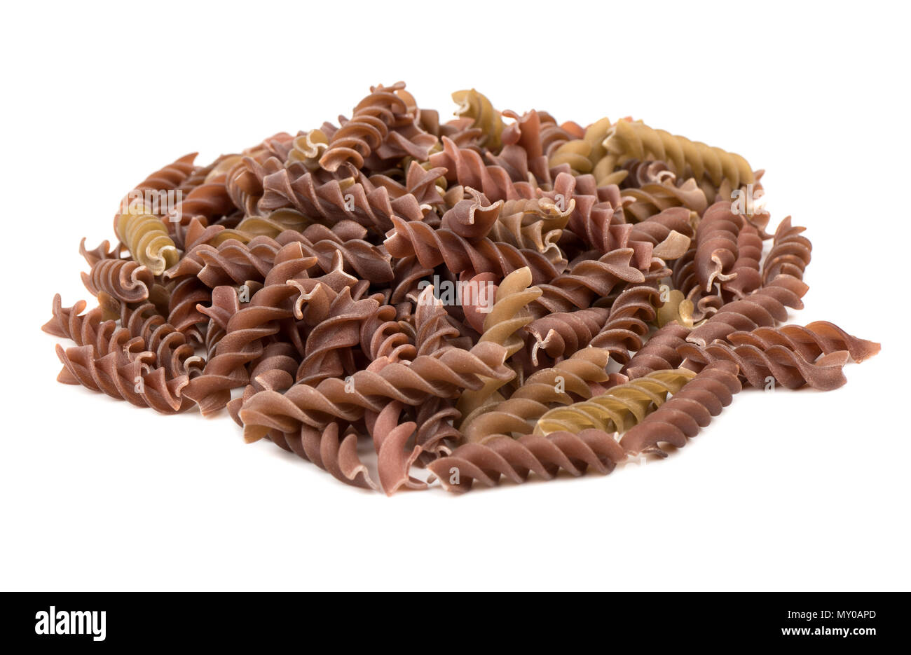 Small dark pile of pasta fusilli on white background Stock Photo - Alamy