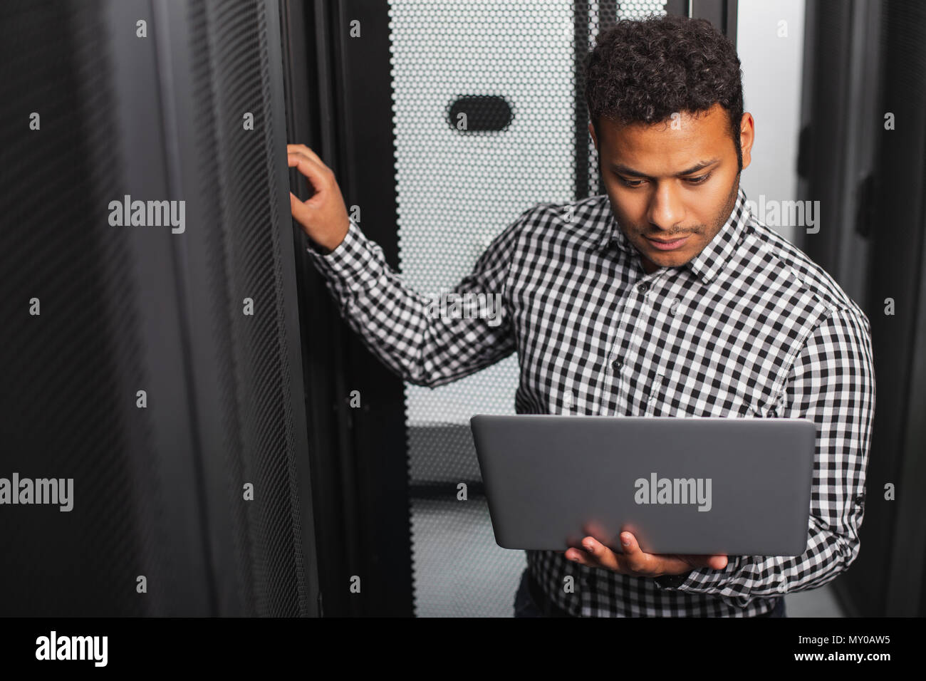 Attractive IT guy conducting checkup Stock Photo - Alamy
