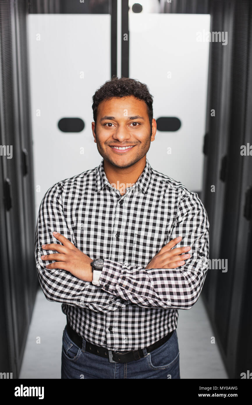Jovial IT guy posing in server room Stock Photo - Alamy