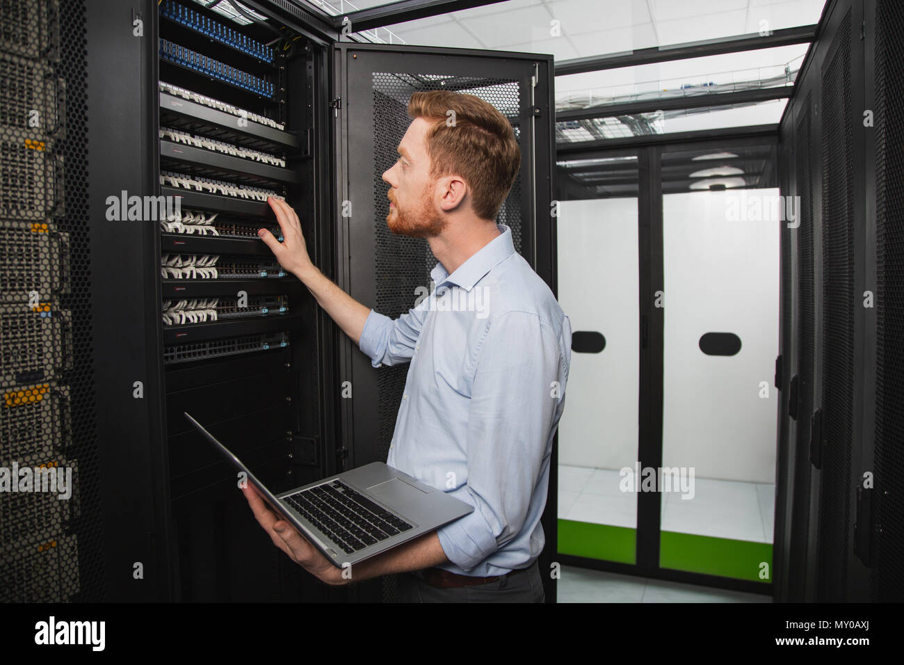 Handsome IT technician performing test Stock Photo - Alamy