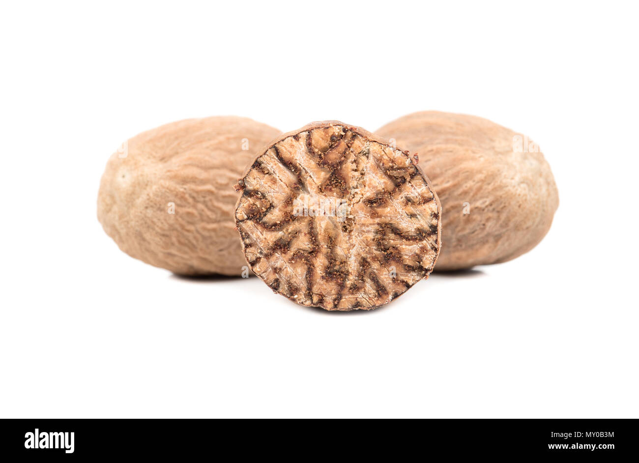 Dry nutmeg with half isolated on white background Stock Photo - Alamy