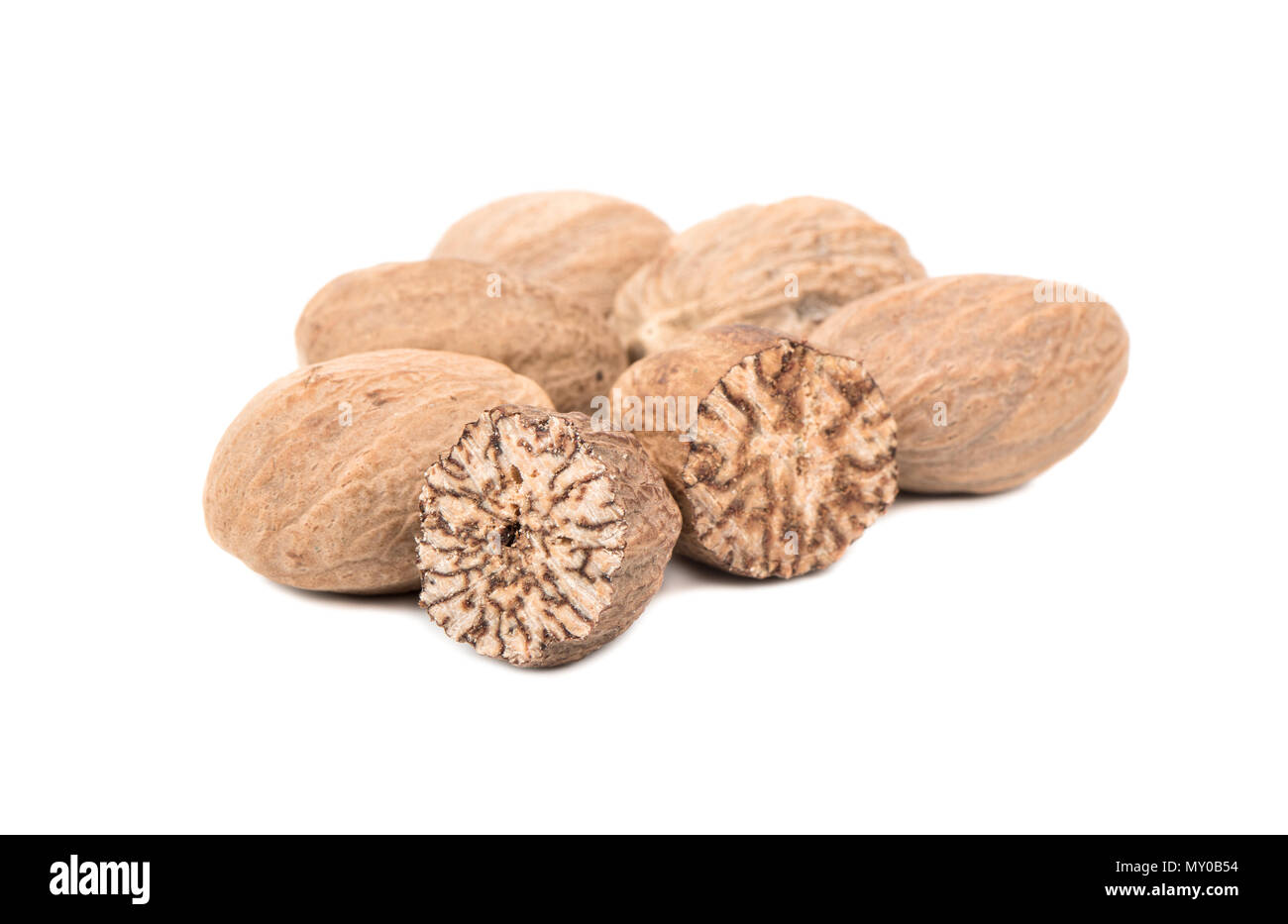 Dry nutmeg with half isolated on white background Stock Photo - Alamy