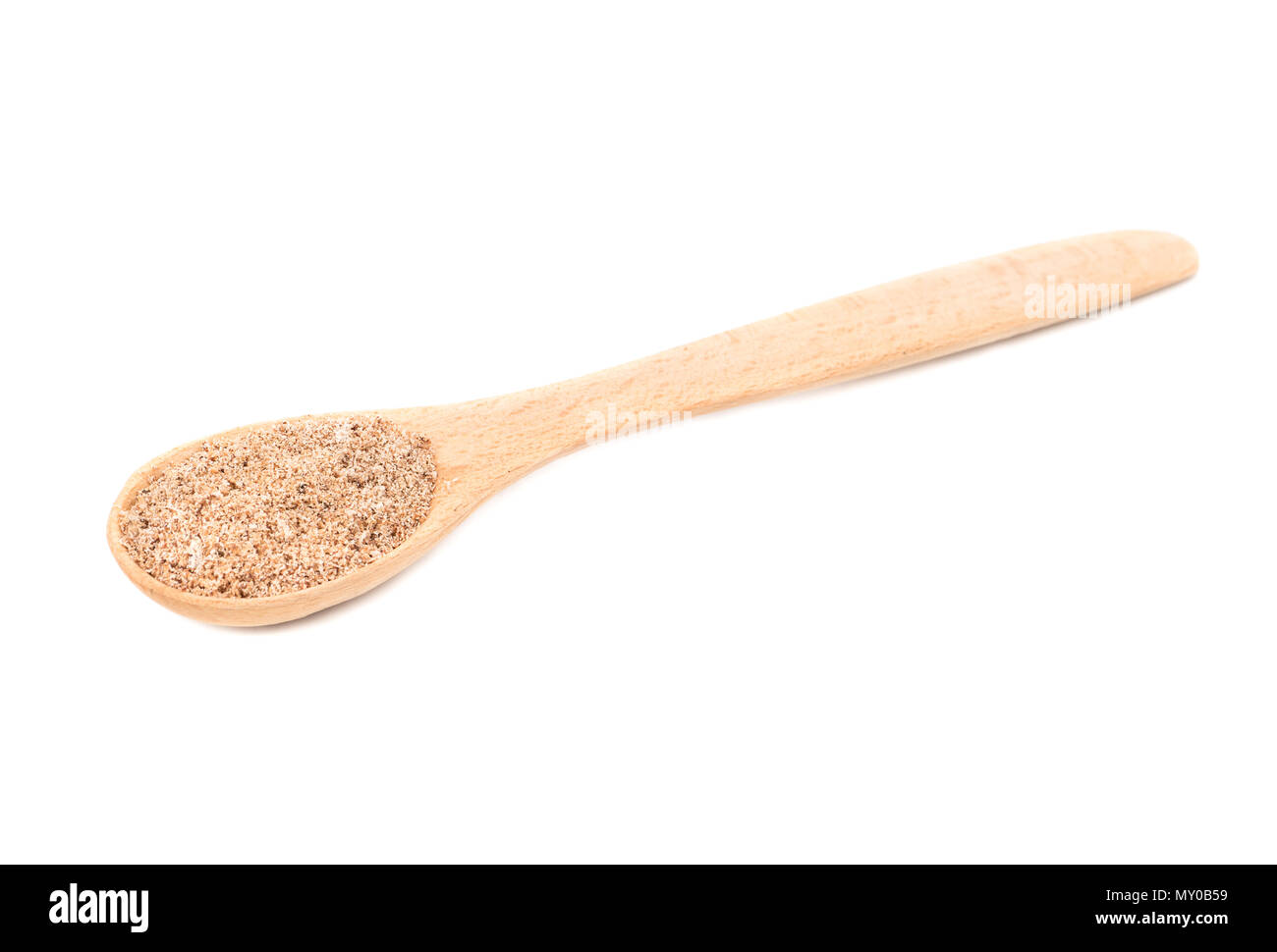 Grind nutmeg in wooden spoon on white background Stock Photo - Alamy