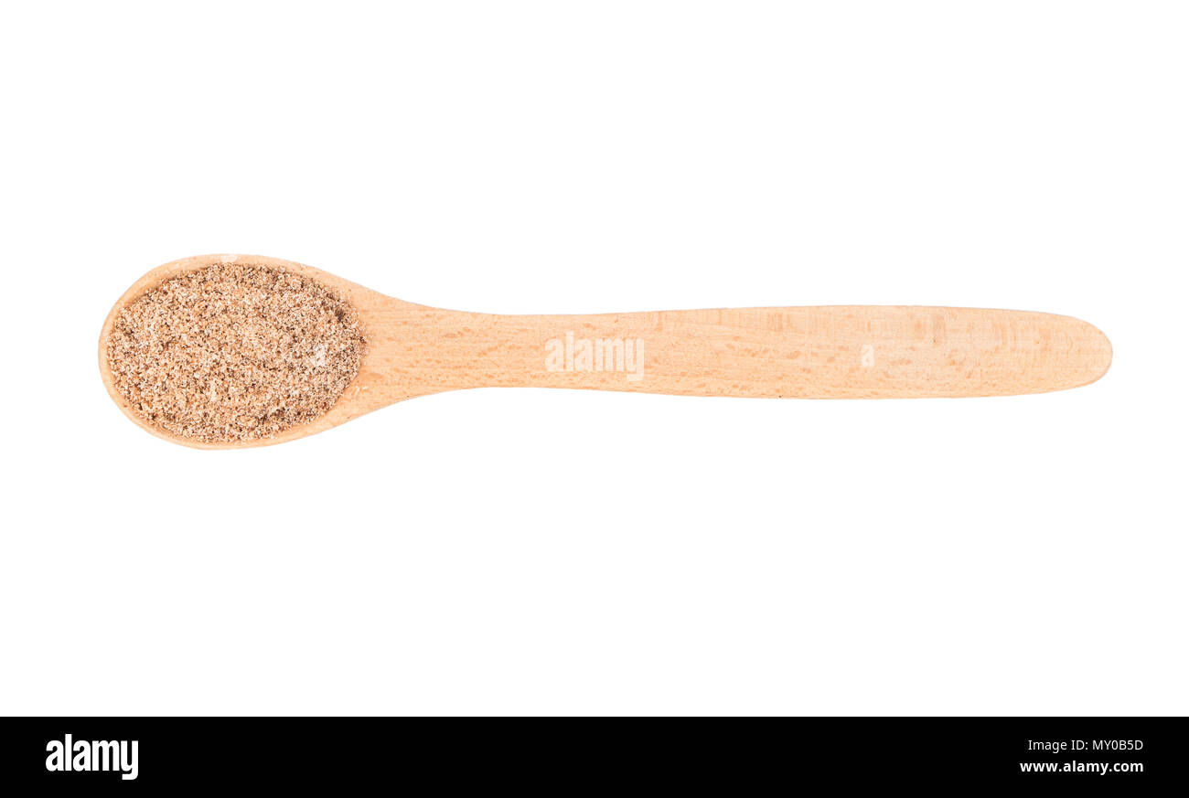 Grind nutmeg in wooden spoon on white background, top view Stock Photo ...