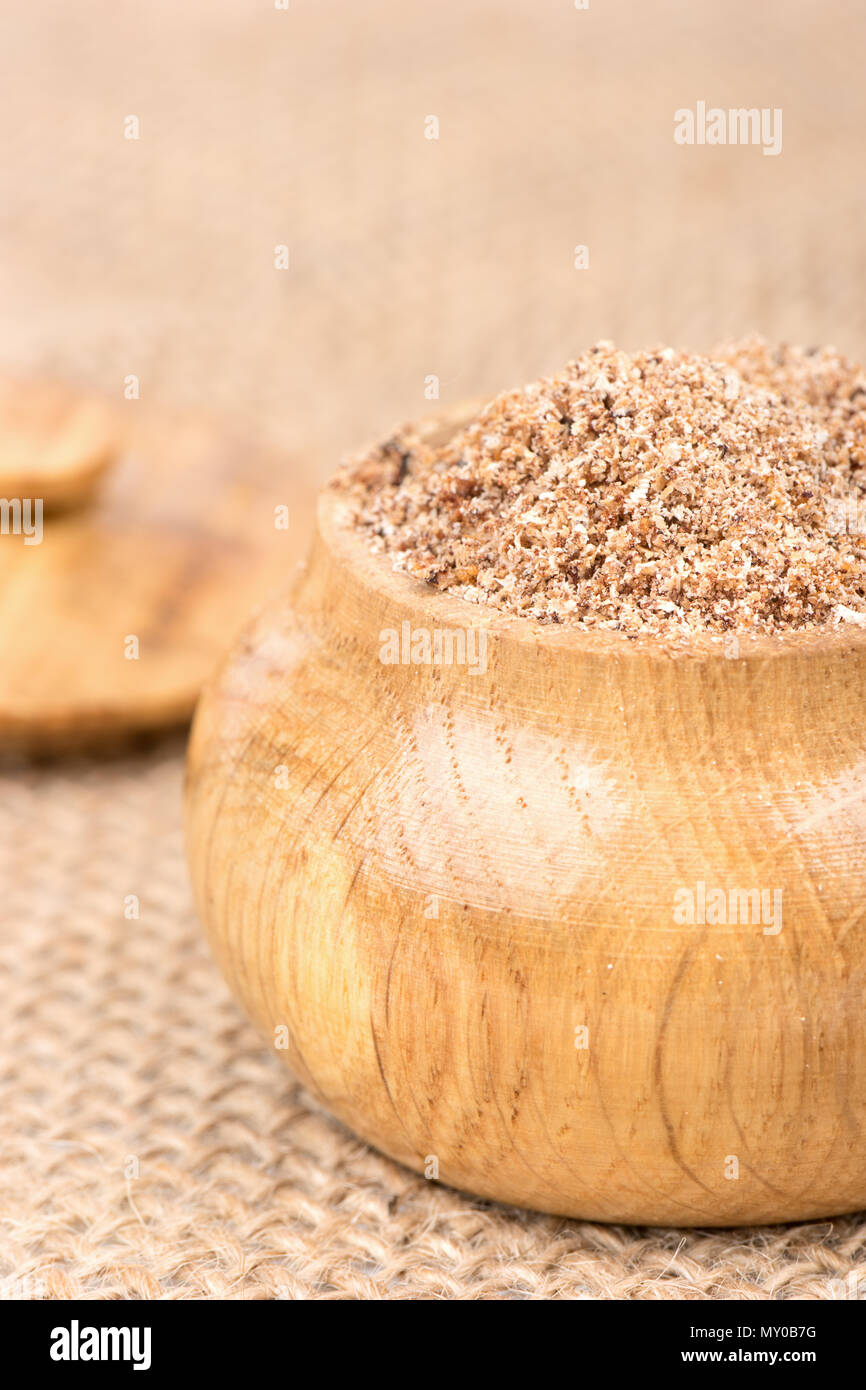 Spice nutmeg in the wooden jar on the burlap Stock Photo - Alamy
