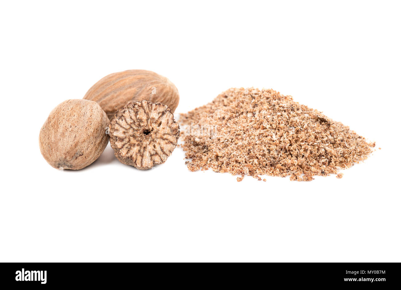 Nutmeg powder, and three nuts on white background Stock Photo - Alamy