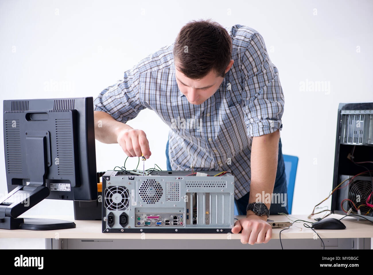 Young technician repairing computer in workshop Stock Photo - Alamy
