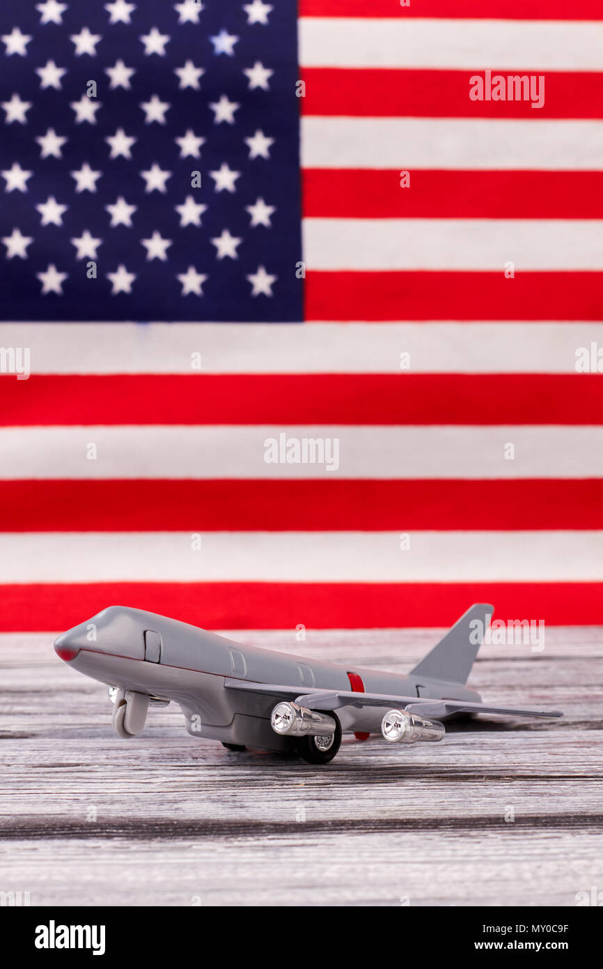 Toy passenger jet plane on USA background. Model of grey toy air plane ...
