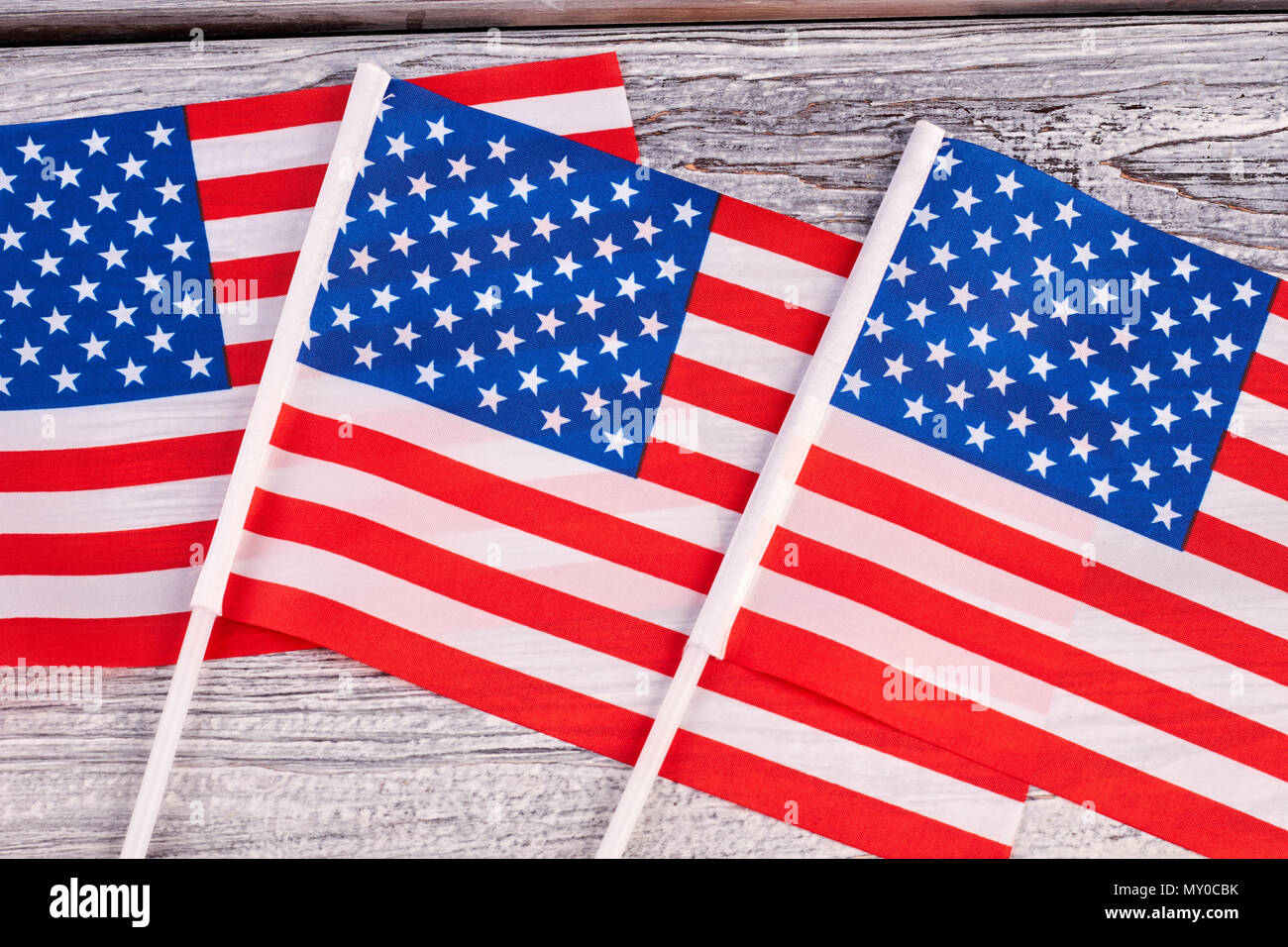 Collection of mini flags of USA close up. Small flags of USA on wooden ...