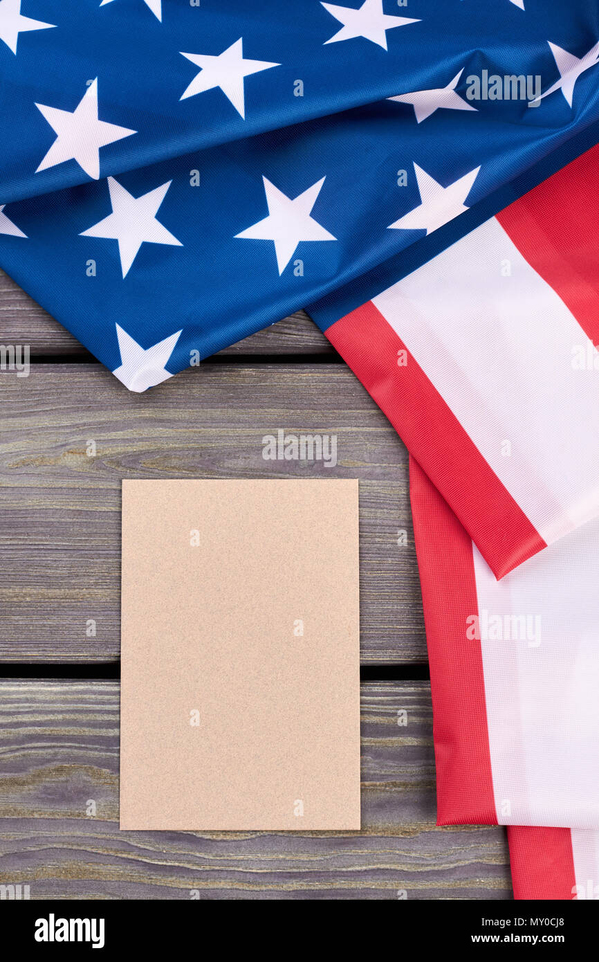 American flag and blank paper sheet. Folded flag of USA and empty ...