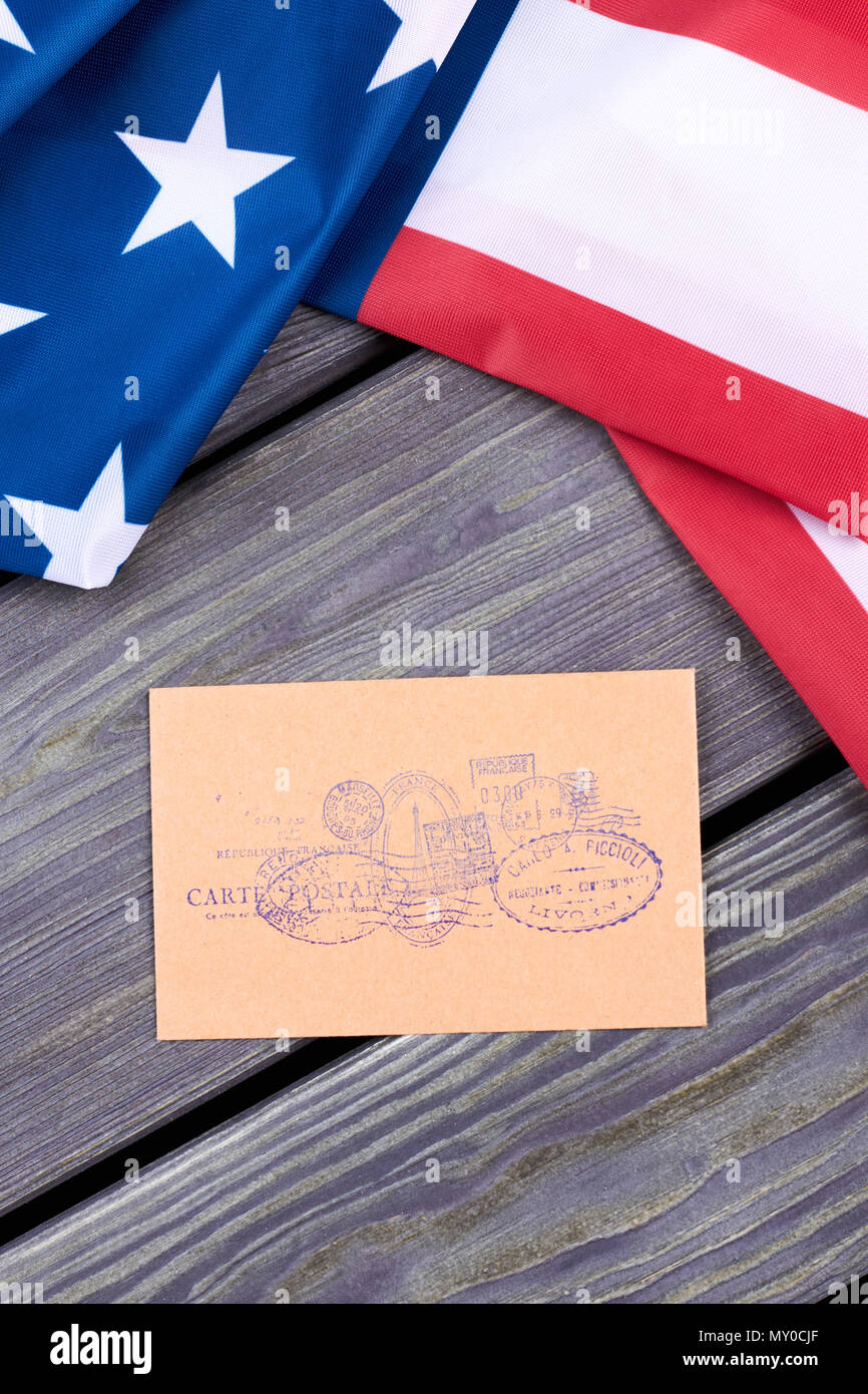 American flag and craft envelope with stamps. Top view on USA flag and ...