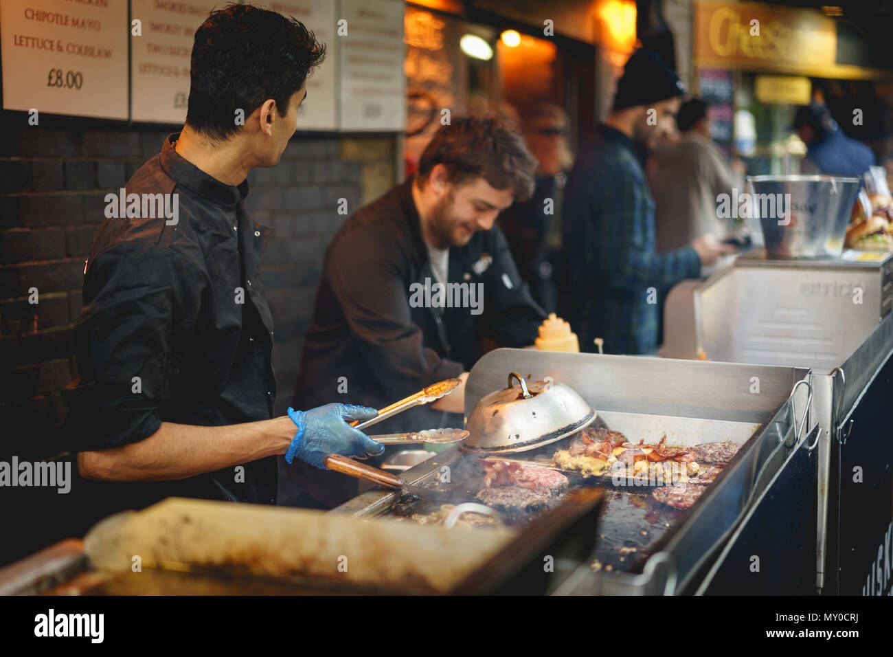 London, UK - November 2017. Burgers prepared in a stall near Borough ...