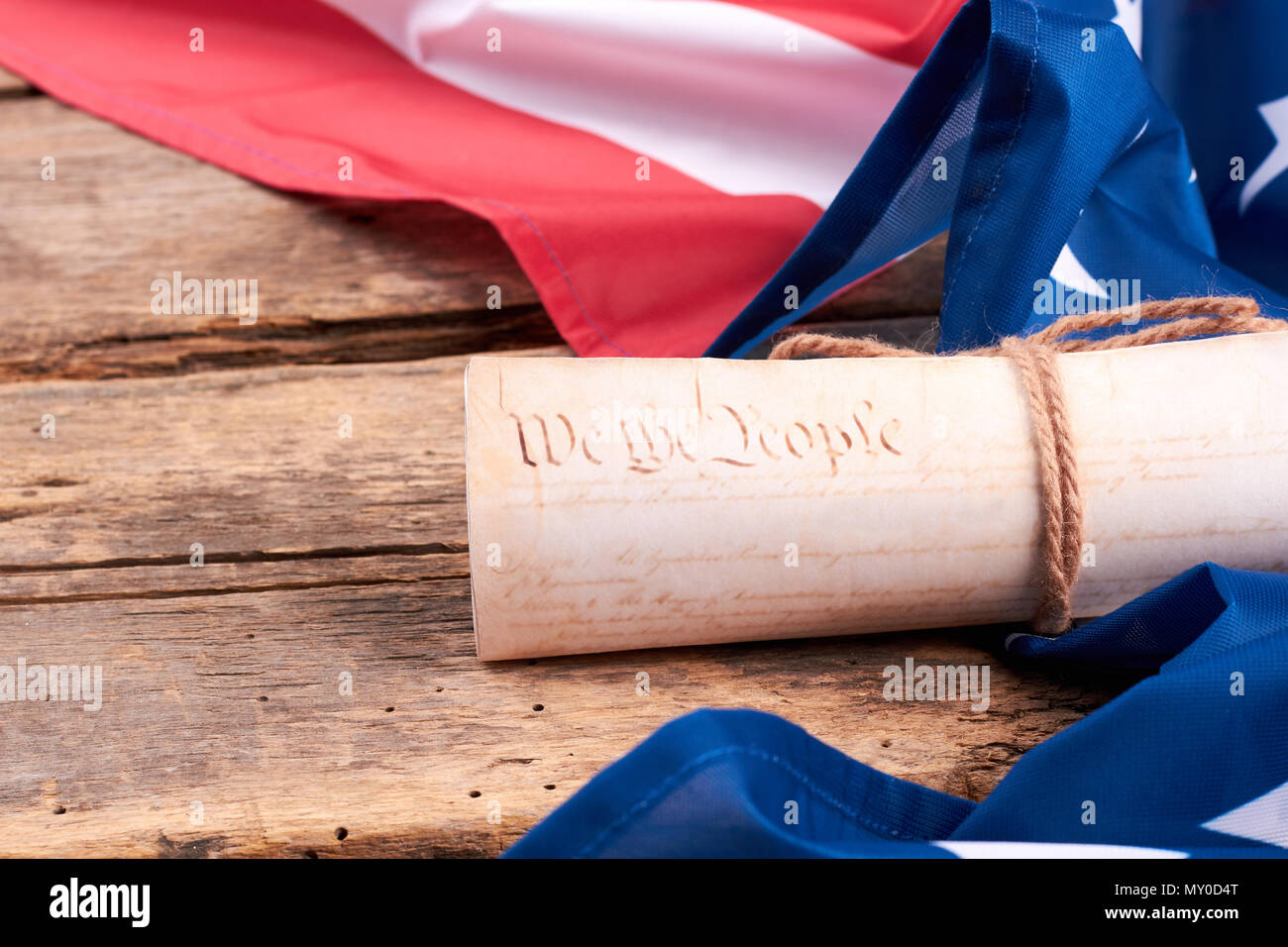 United States flag and rolled-up Constitution. United States ...
