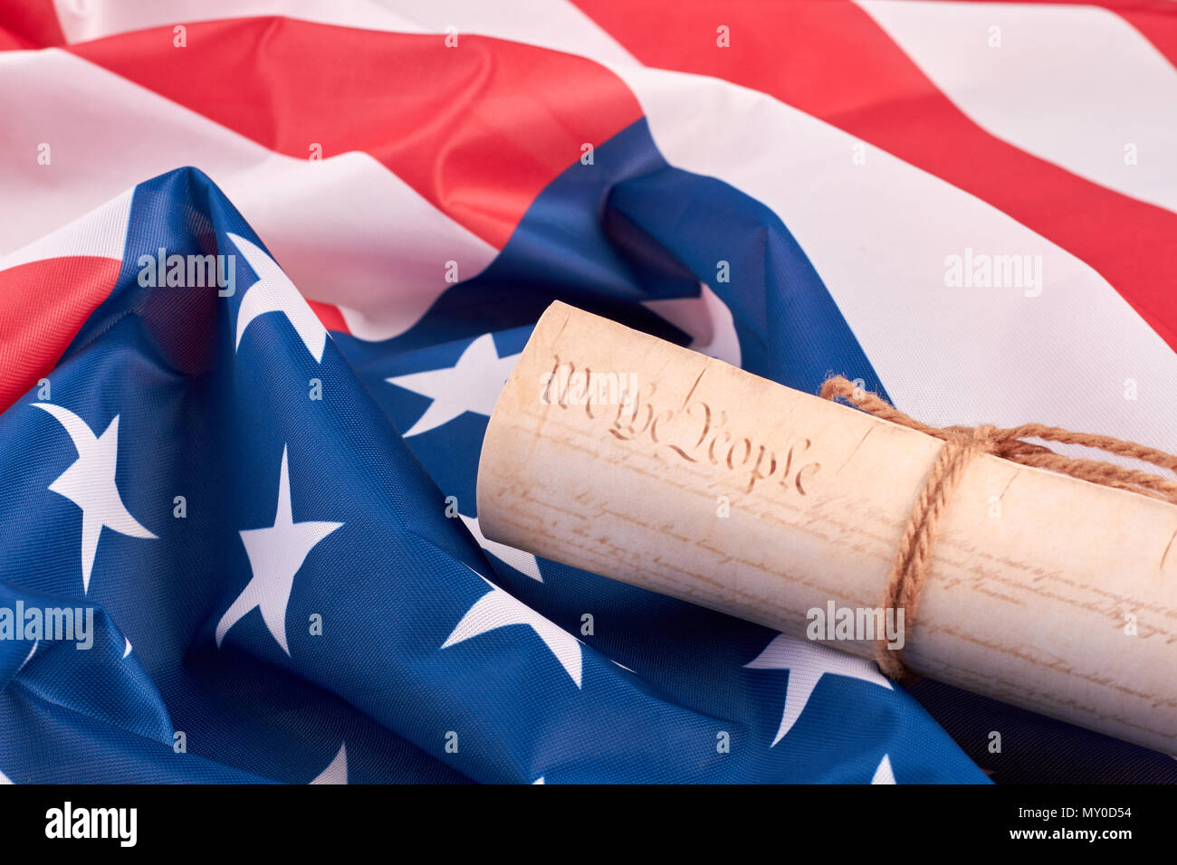 USA flag and Constitution close up. Constitution of America rolled in ...