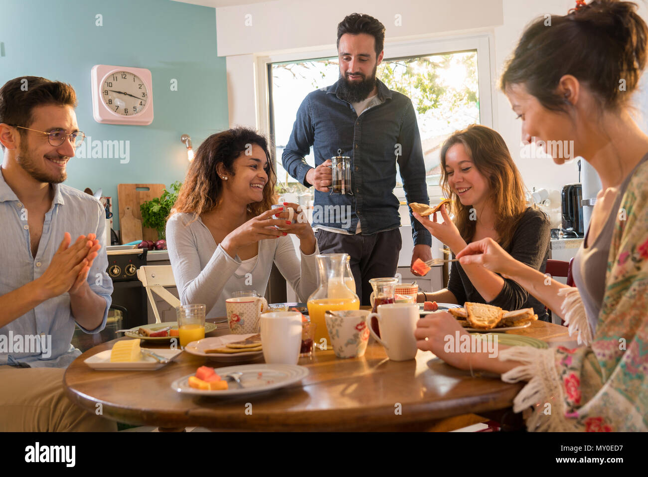 Group friends gathered around table hi-res stock photography and images ...