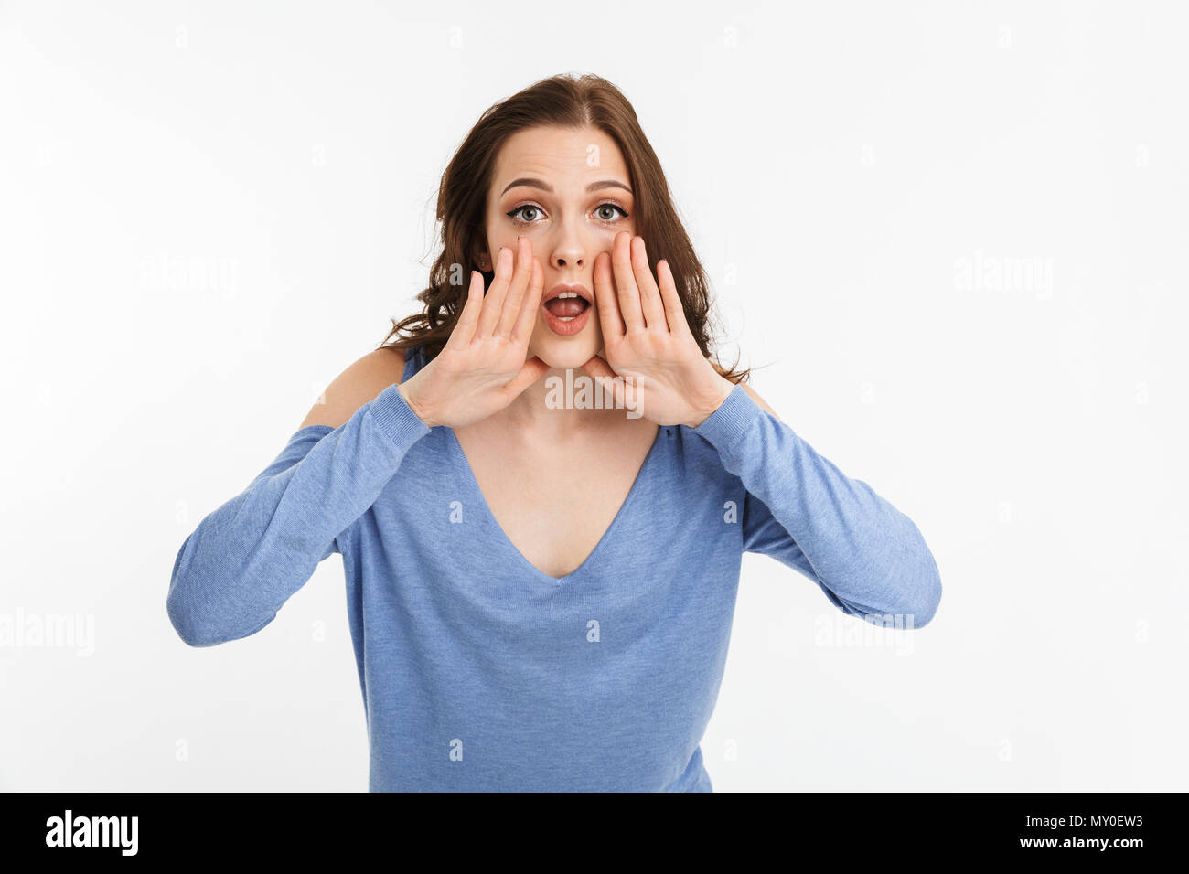 Portrait of a worried young woman shouting loud isolated over white ...