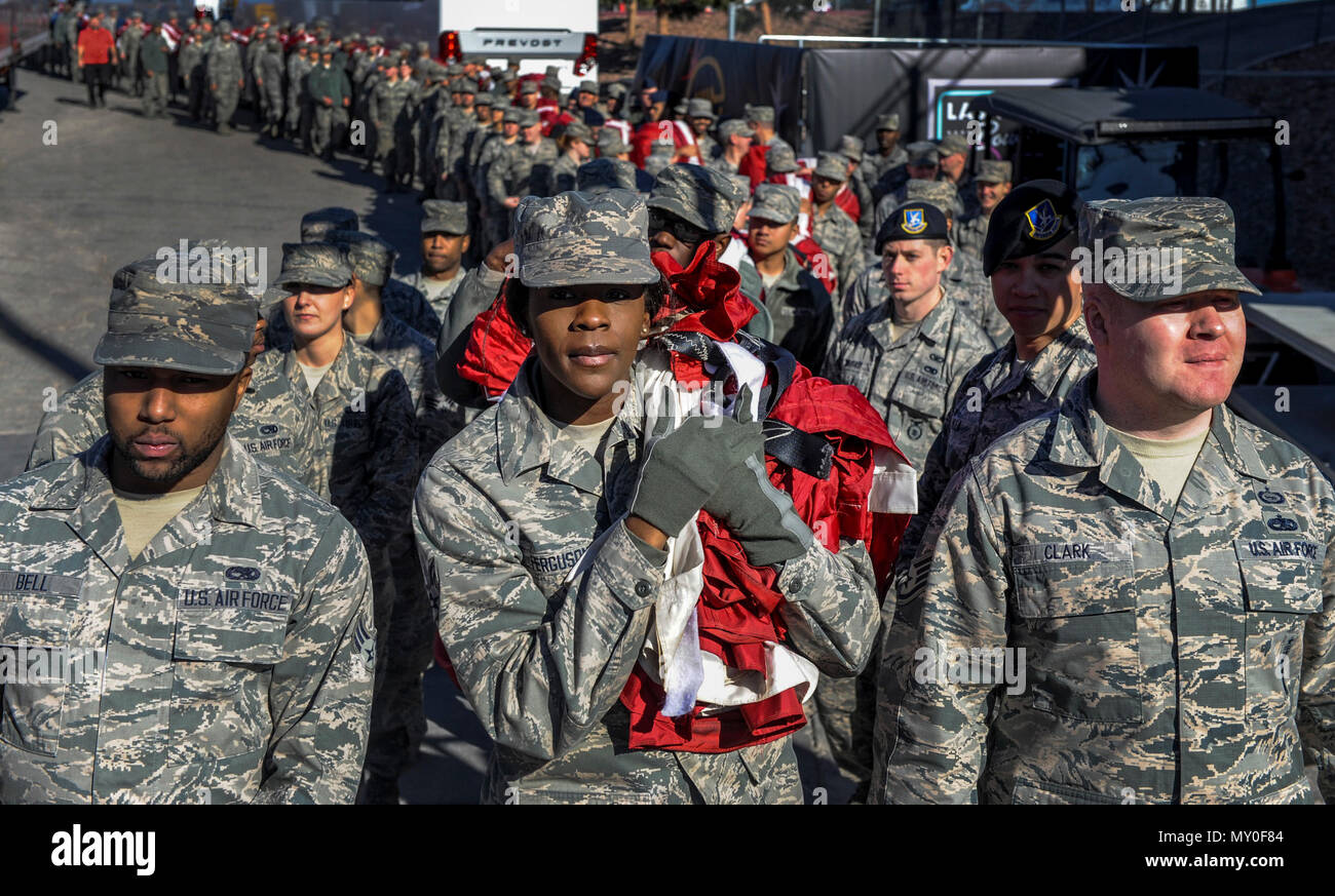 Airmen from Nellis and Creech Air Force Bases carry a large American ...