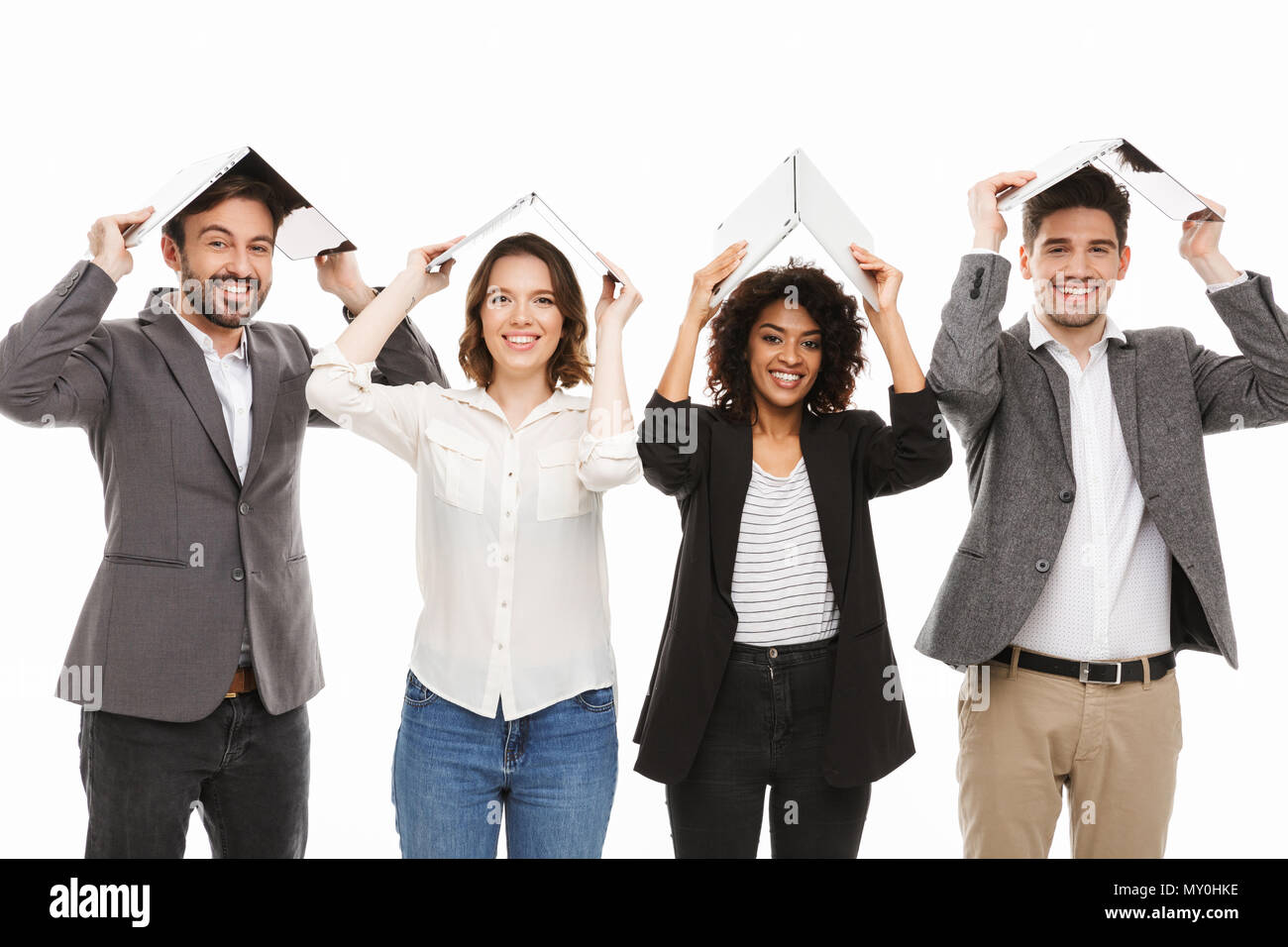 Portrait of a group of happy multiracial business people holding laptop ...