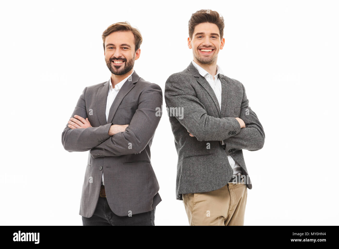 Portrait of a two confident business men standing with arms folded ...