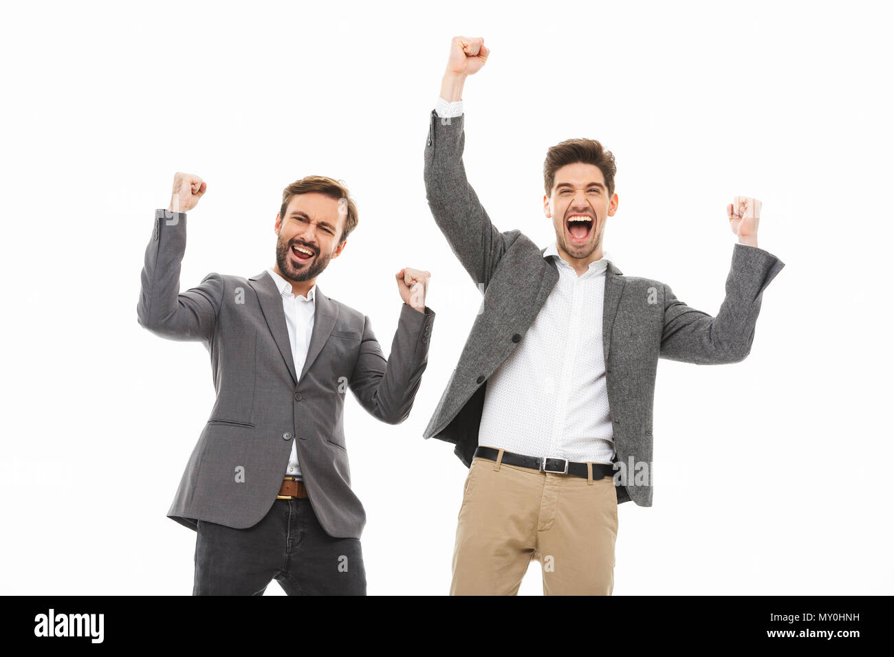 Portrait of a two happy business men celebrating success isolated over ...