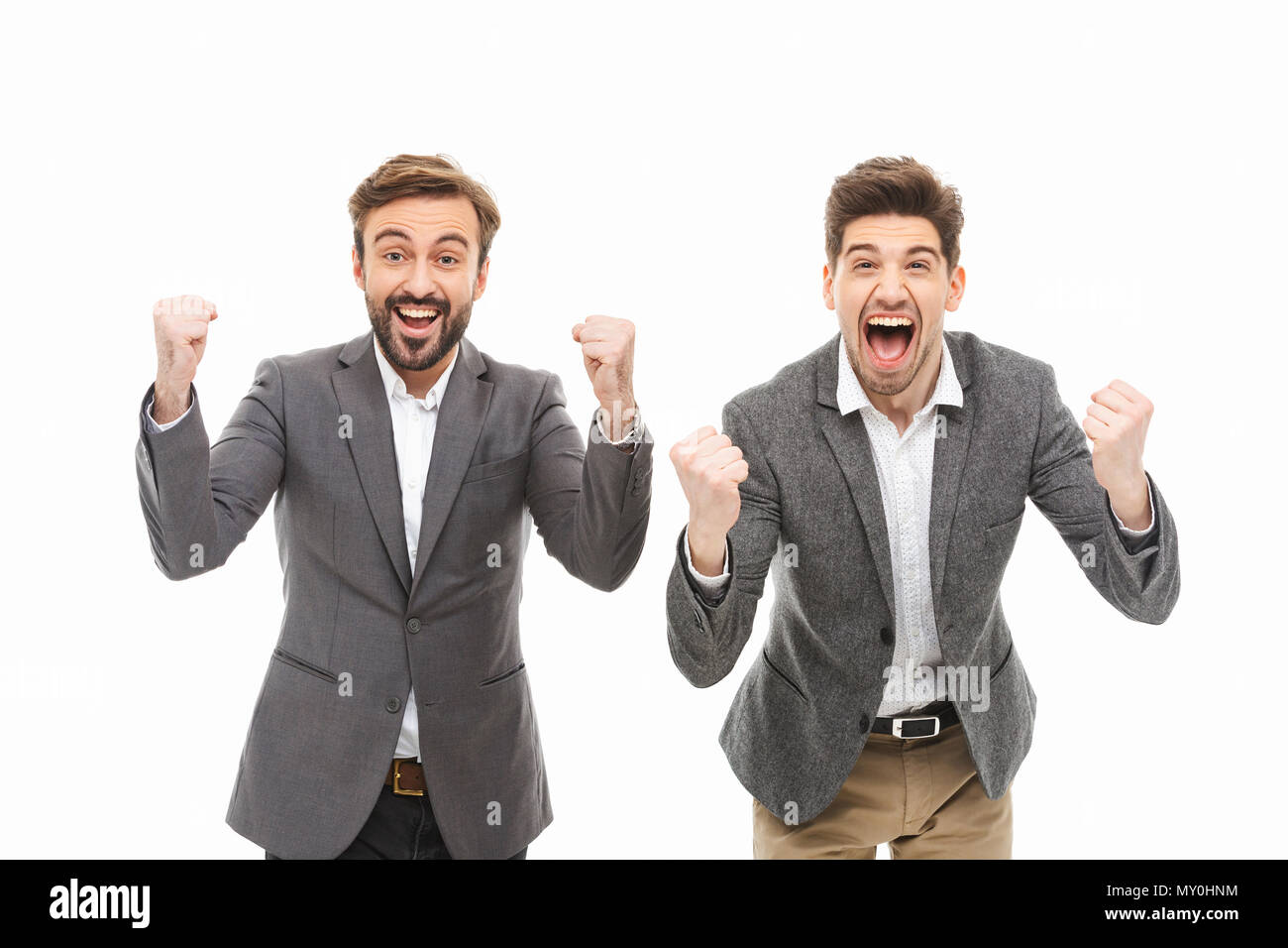 Portrait of a two excited business men celebrating success isolated ...