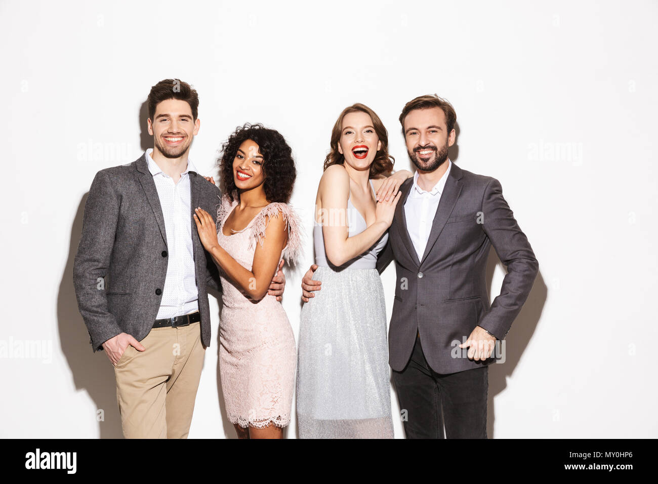 Group of well dressed multiracial people standing together isolated ...