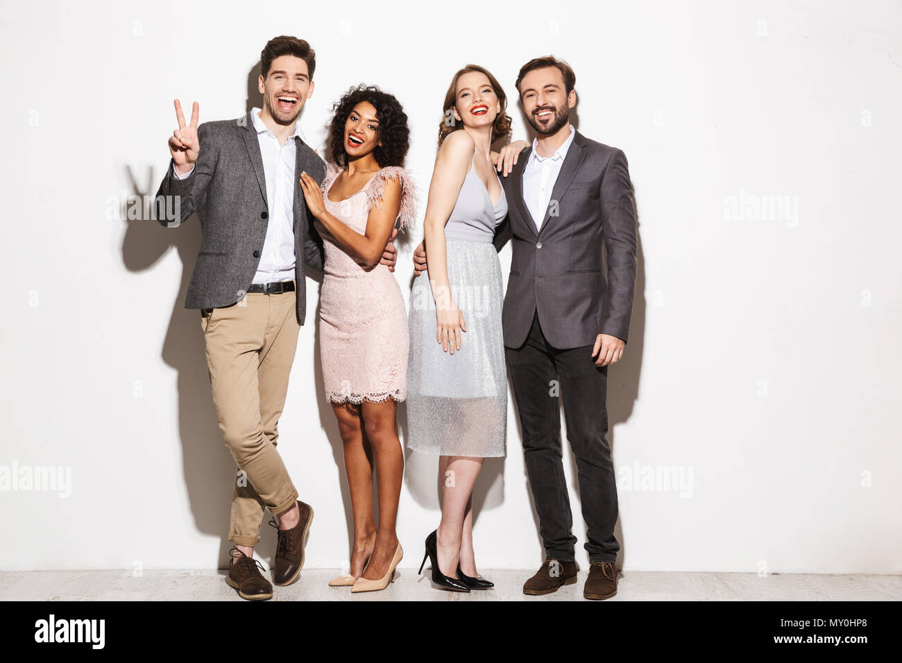 Group of happy well dressed multiracial people standing together ...