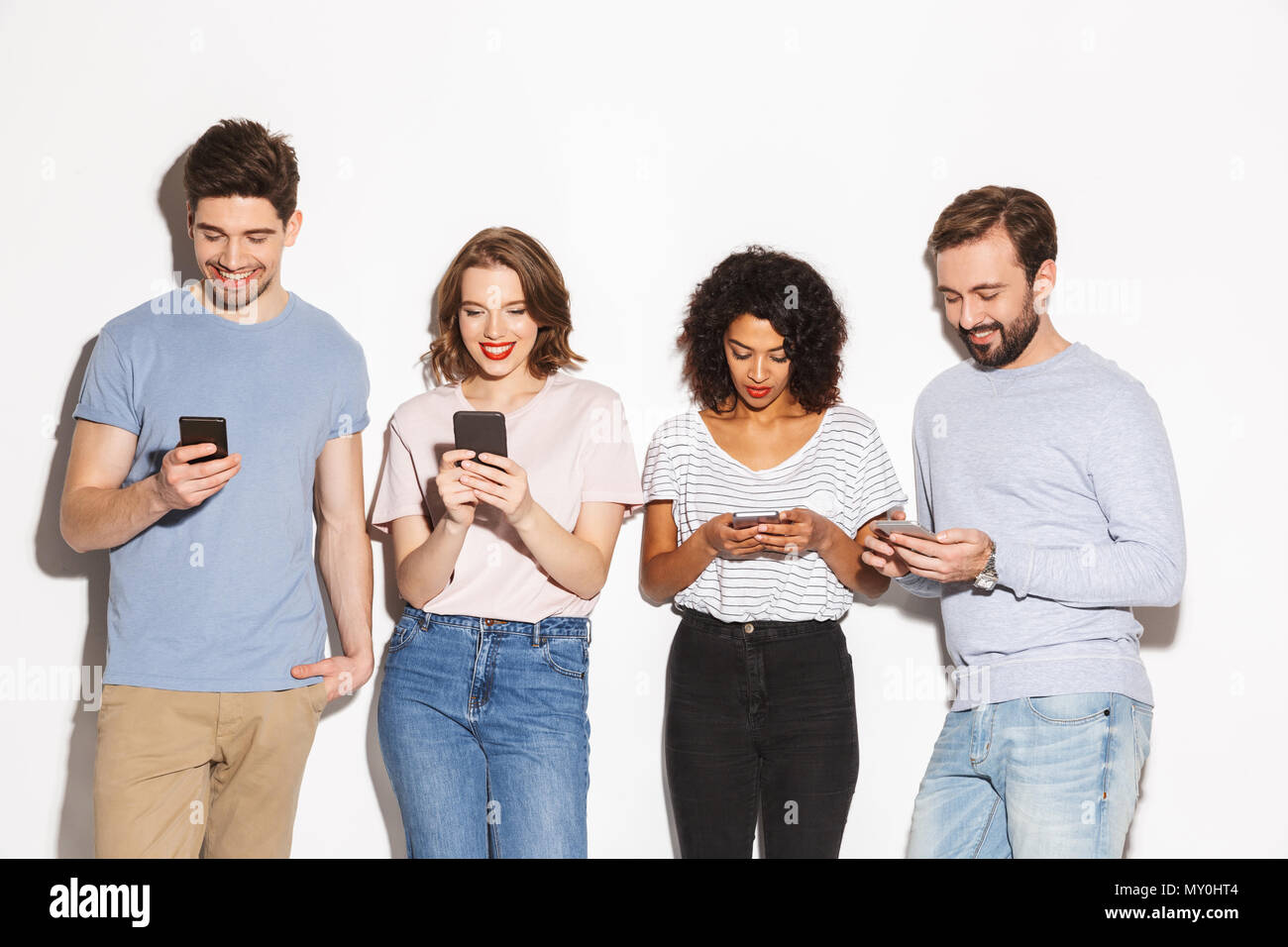 Group of happy multiracial people using mobile phones isolated over ...