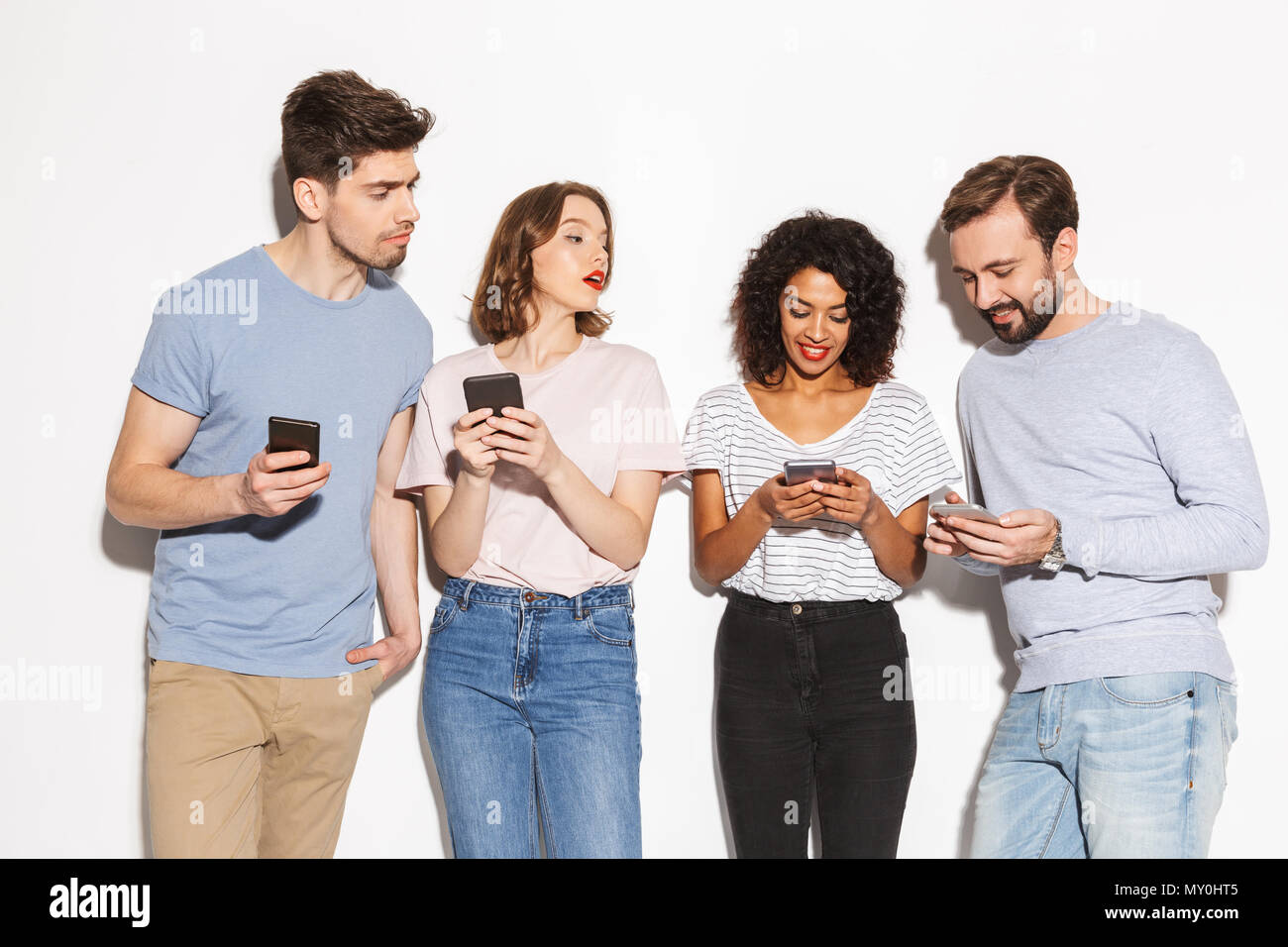 Group of modern multiracial people using mobile phones isolated over ...
