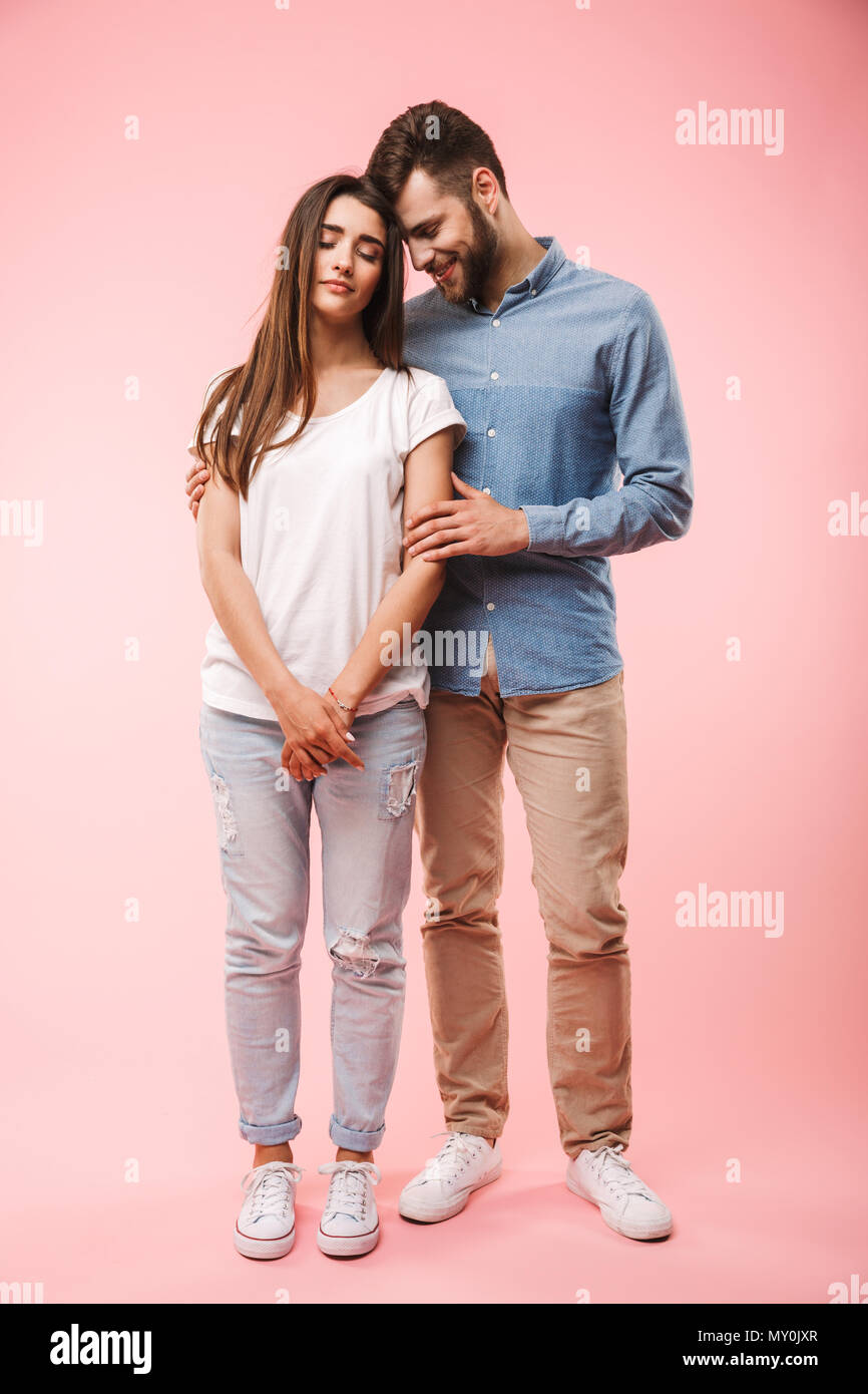 Full length portrait of lovely young couple hugging while standing ...