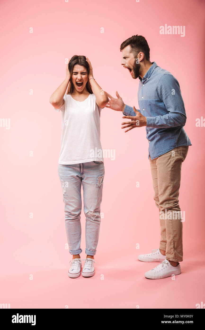 Full length portrait of a furious young couple having an argument ...