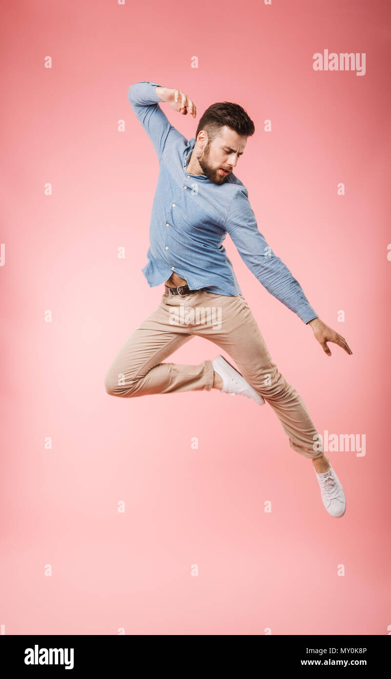 Full length of a handsome young man jumping and celebrating success ...